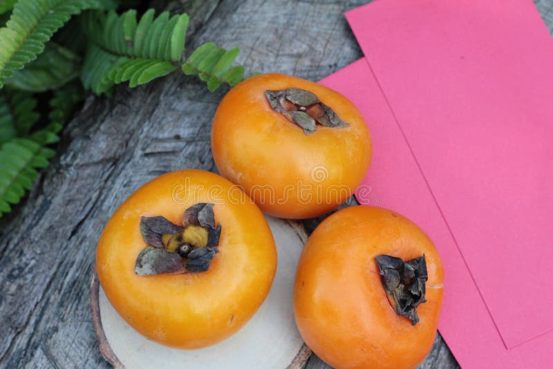 Persimmons Fruit with Red Envelopes, Chinese New Year. Stock Image ...