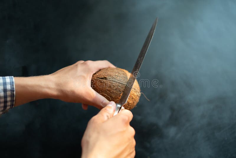 Person with Big Knife Try To Open and Break a Coconuts Stock Photo ...