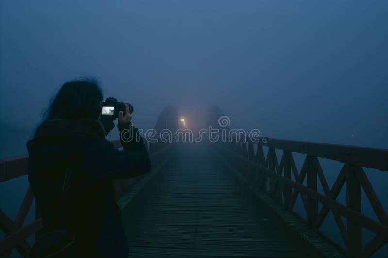 Person with Camera Capturing Foggy Bridge at Night Stock Image - Image ...