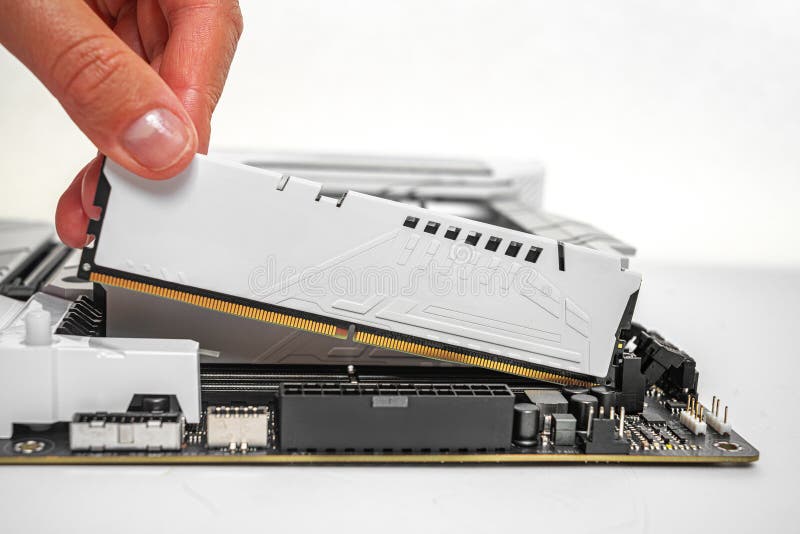 A Person is Carefully Inserting a White DDR RAM Module into a ...
