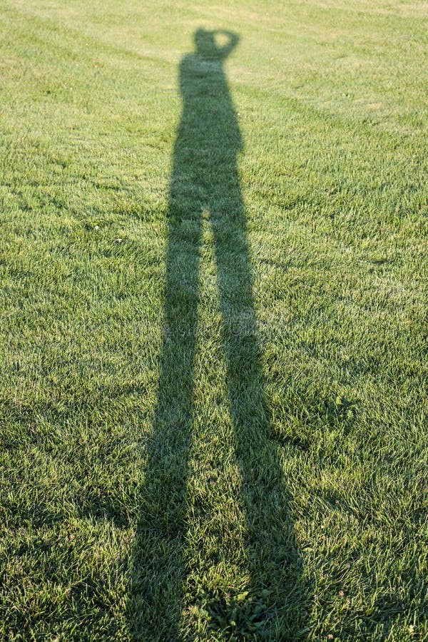 Person Casting Shadow on Grass Stock Image - Image of lawn, shadows ...