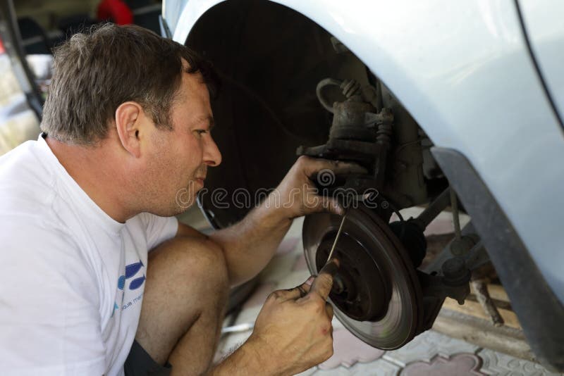 Person changes brake pads stock image. Image of change - 127061263