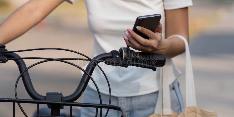 Person Checking Smartphone while Holding Bicycle Handlebars ...
