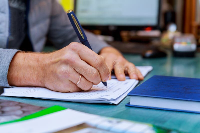 Person Completing Man Hand with Pen and Business of Application Form ... Person Completing Man Hand with Pen and Business of Application Form ...