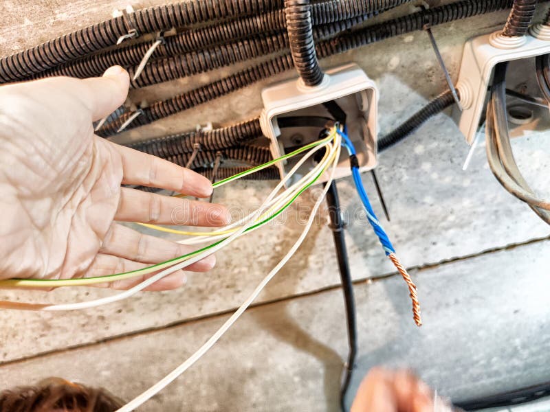 A Person Connecting Multiple Colored Electrical Wires Inside a Junction ...