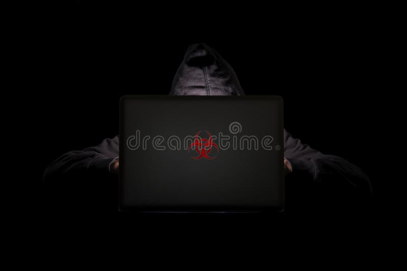 A Person in a Dark Room Using a Laptop with a Biohazard Logo, Internet ...