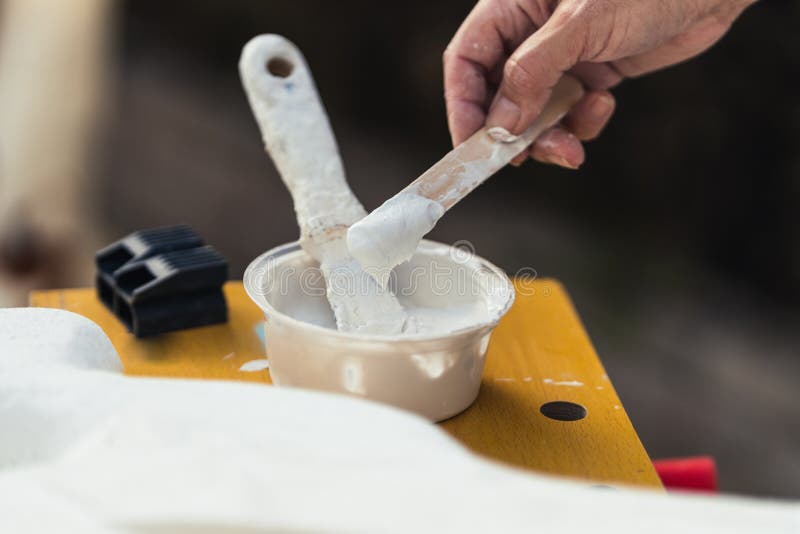 Person Dipping White Paste with a Spatula in a Workshop Stock Photo ...