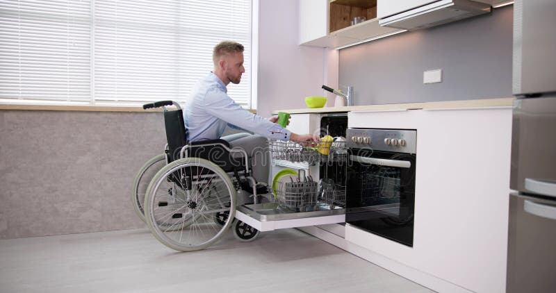 Person with Disability in Wheelchair Using Dishwasher Stock Photo ...