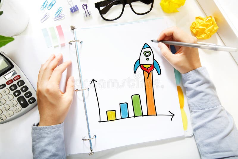 Person Drawing Rocket Graph on White Paper Stock Image - Image of ...