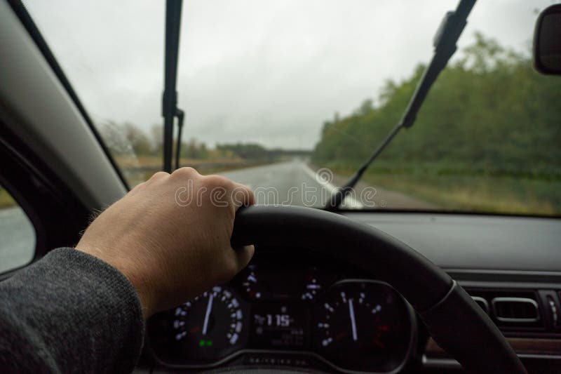 A Person is Driving a Car with the Windshield Wipers on Stock Image ...