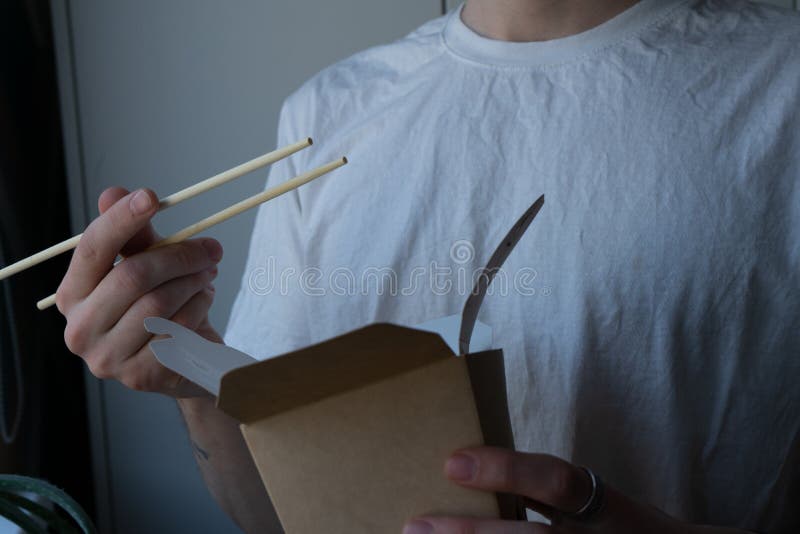 Person eats with sticks stock photo. Image of eatery - 248655378
