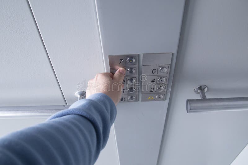 The Person in the Elevator Presses the Button To Start Moving Stock ...
