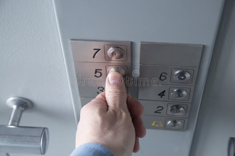 The Person in the Elevator Presses the Button To Start Moving Stock ...
