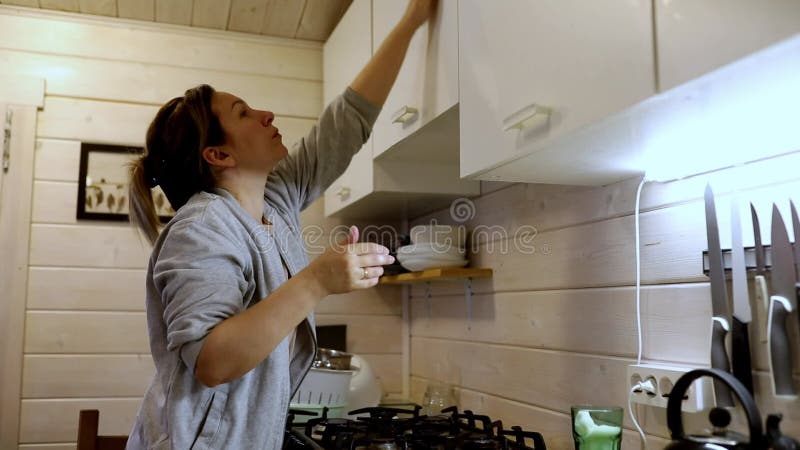 Cleaning Kitchen Cabinets at a Cozy Cabin during the Afternoon Stock ...