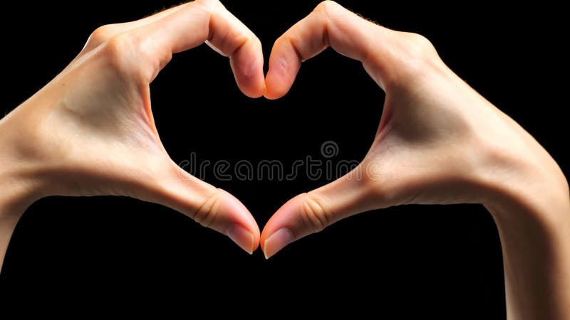 A Person Forms a Heart Shape Using Their Hands Against a Dark Backdrop ...