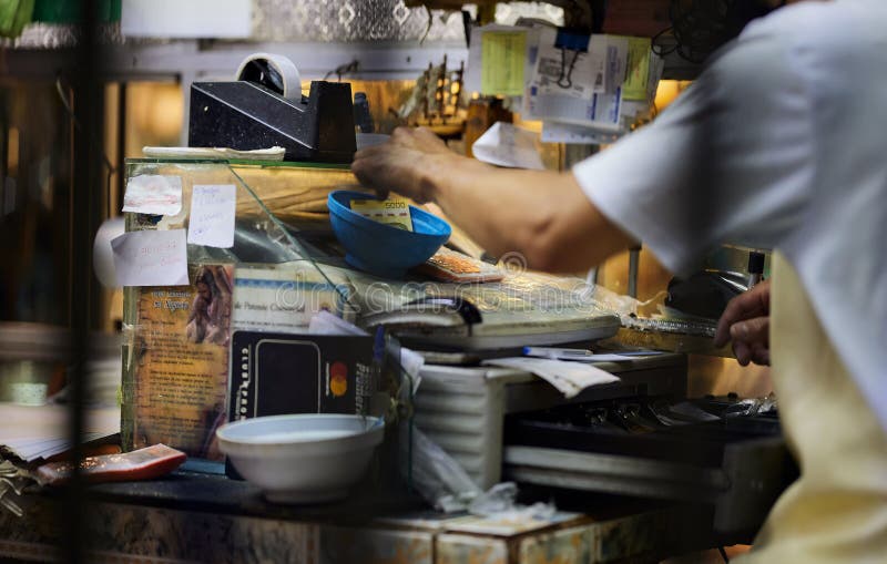 Person in Front of the Cash Box in a Store with Messy Surrounding Stock ...