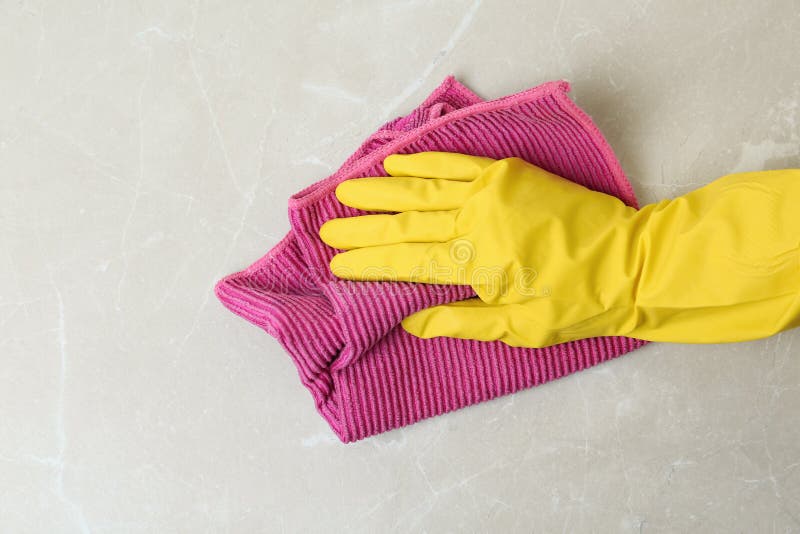 Person in Gloves Wiping Grey Table with Rag, Top View Stock Photo ...