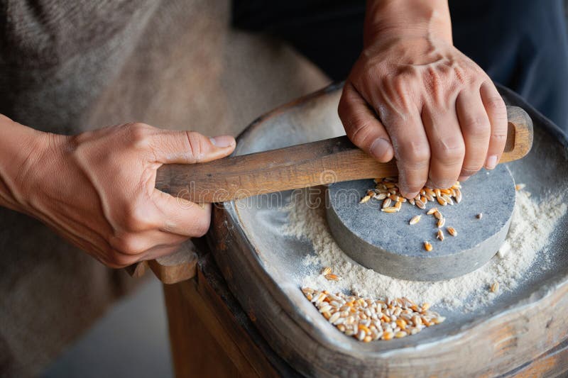 A Man Grinding Grains Using a Traditional Stone Mill. Ai Generated ...