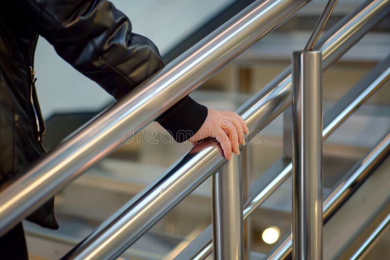 Person Gripping a Metallic Handrail on a Staircase Stock Image - Image ...