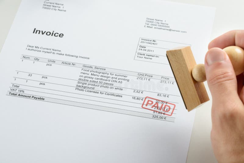 Person Hand Holding Rubber Stamp Over Paid Invoice Stock Image - Image ...
