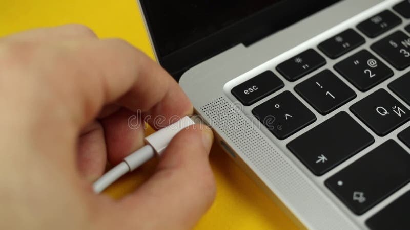 Person Hand Pull Out or Extract a USB-C Cable Charger from Computer or ...