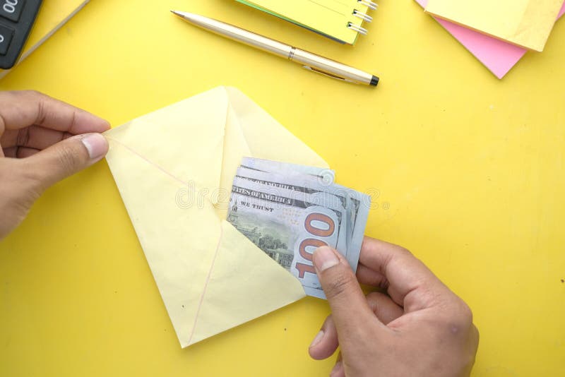 Person Hand Putting Cash in a Envelope. Stock Image - Image of finance ...