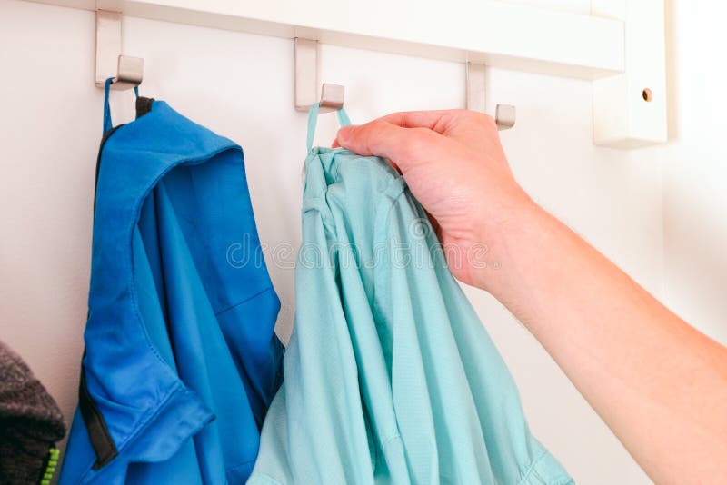 Person Hand Taking Off Jacket from Cloth Hook Hanger Stock Photo ...