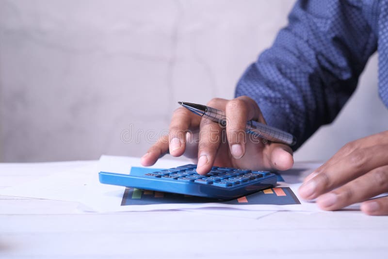 Person Hand Using Calculator and Writing on Notebook Stock Photo ...