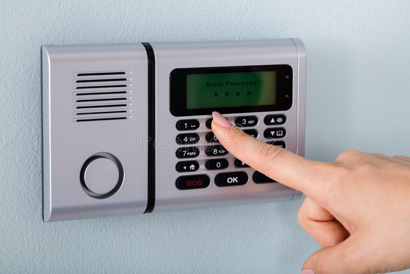 Security Alarm Keypad with Person Disarming the System Stock Image ...