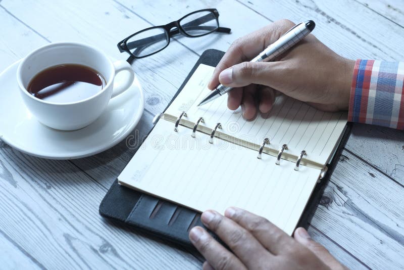 Person Hand Writing on Notepad at Office Desk Stock Image - Image of ...