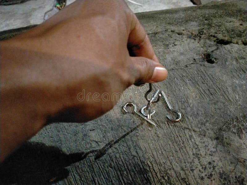 The Person is Handling the Stainless Hook To Lift the Other Hooks for ...