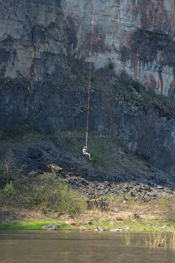 A Person Hanging Above the River on the Rope Stock Image - Image of ...