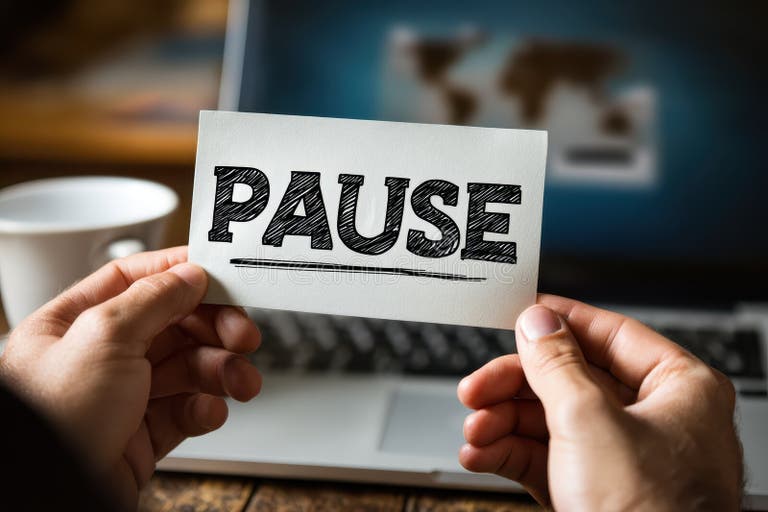 Person Holding a Card with the Word Pause in Front of a Computer Sleep ...
