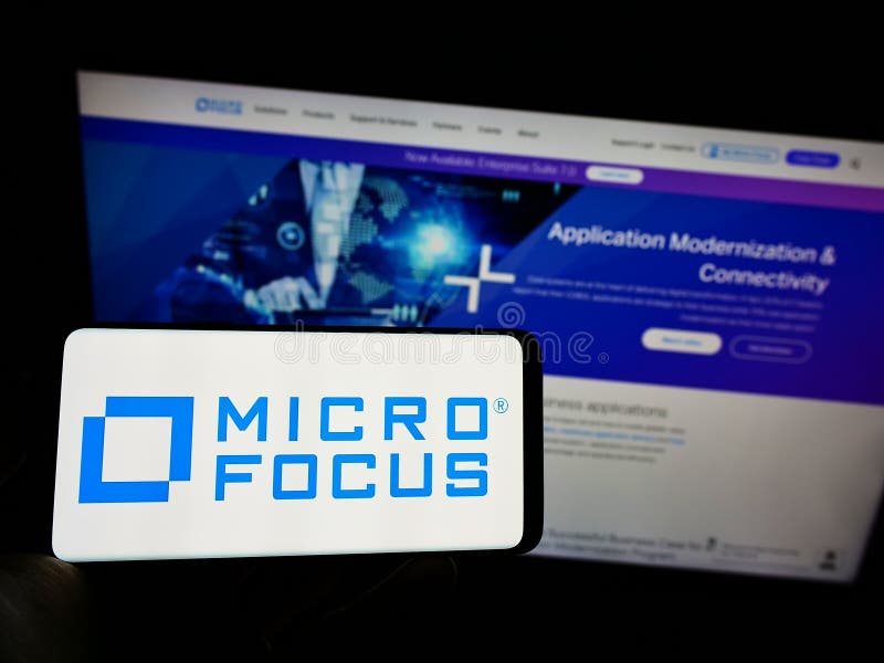 Person Holding Cellphone with Logo of British Software Company Micro ...