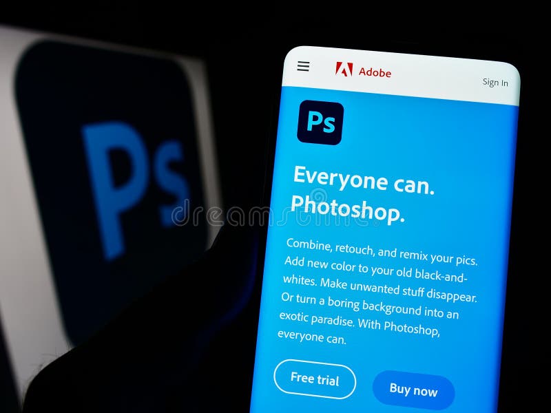 Person Holding Cellphone with Webpage of Graphics Editor Software Adobe ...