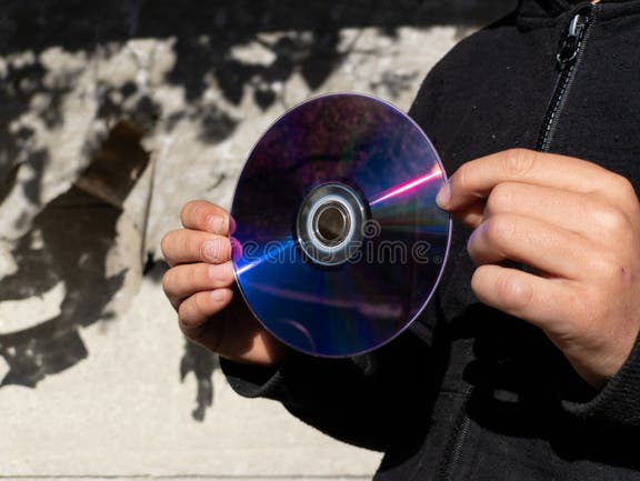 A Person Holding a Compact Disc in Their Hands Stock Image - Image of ...
