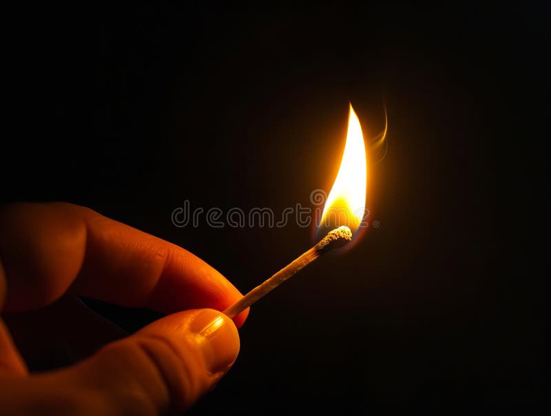 A Person Holding a Matchstick in Their Hand with a Lit Match in the ...