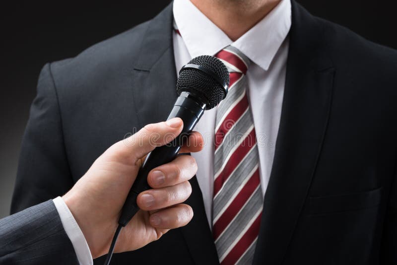 Person Holding Microphone in Front of Businessman Stock Photo - Image ...