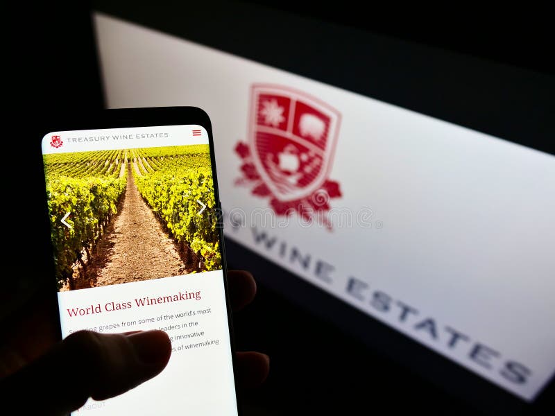 Person Holding Mobile Phone with Website of Australian Company Treasury ... Person Holding Mobile Phone with Website of Australian Company Treasury ...