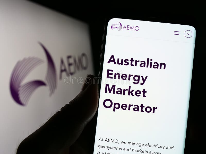 Person Holding Mobile Phone with Website of Australian Energy Market ... Person Holding Mobile Phone with Website of Australian Energy Market ...
