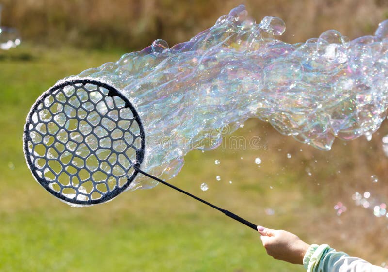 A Person is Holding a Net and a Bubble Wand Stock Photo - Image of ...