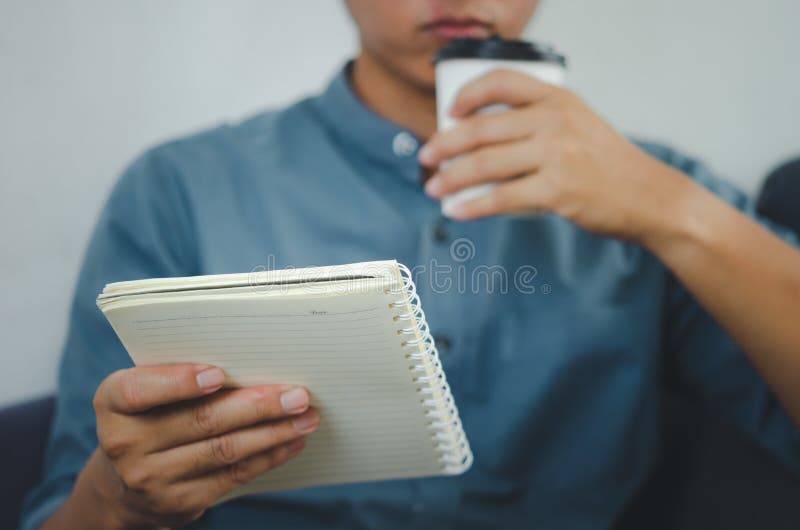 Person Holding a Note Book and a Paper Coffee Cup Stock Photo - Image ...