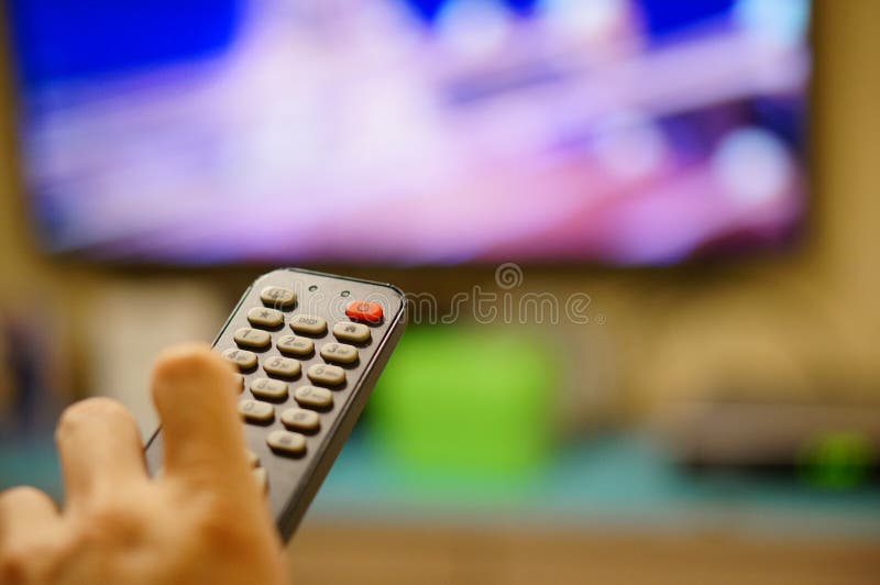 Person Holding a Remote Control on a Blurred Background Stock Photo ...