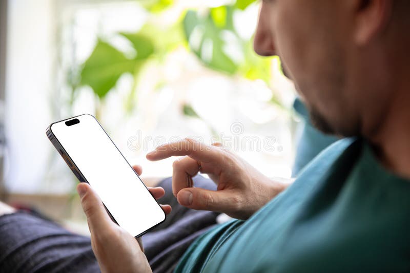 Person Holding a Smartphone with a Blank Screen, Relaxing on a Sofa in ...