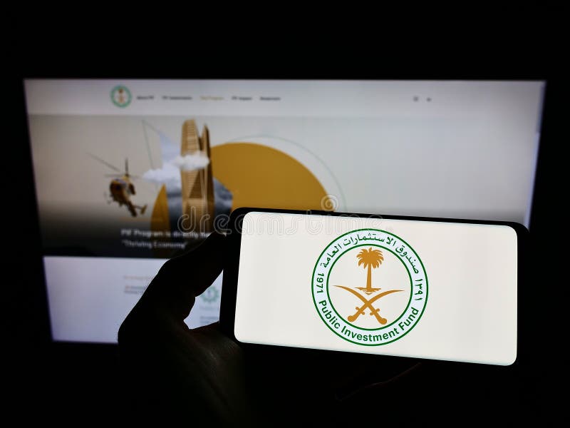 Person Holding Smartphone with Logo of Saudi Arabian Public Investment ... Person Holding Smartphone with Logo of Saudi Arabian Public Investment ...