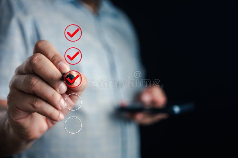 The Person Holding a Smartphone Ticks the Checkmark in the Box on the ...