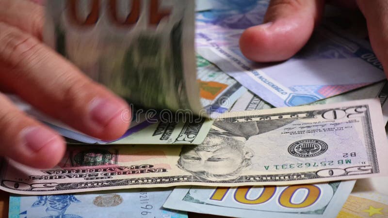 A Person is Holding a Stack of Banknotes and Coins Stock Video - Video ...