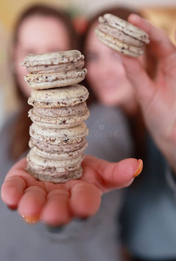 Vertical Shot of a Person Holding a Stack of Macaroons Stock Photo ...