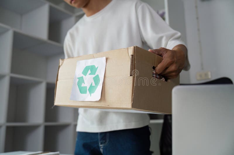 Individual Carrying a Box Marked for Recycling, Focusing on Sustainable ...