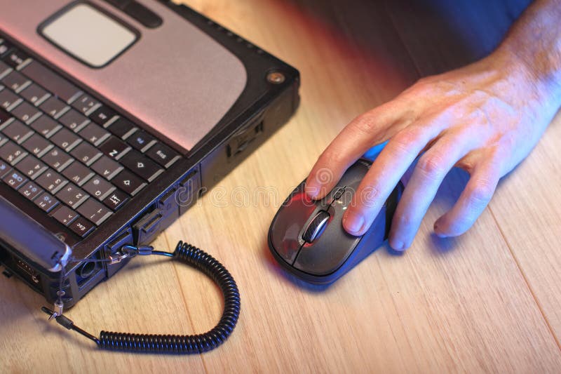 A Person Holds a Computer Mouse Next To an Old Laptop Stock Image ...